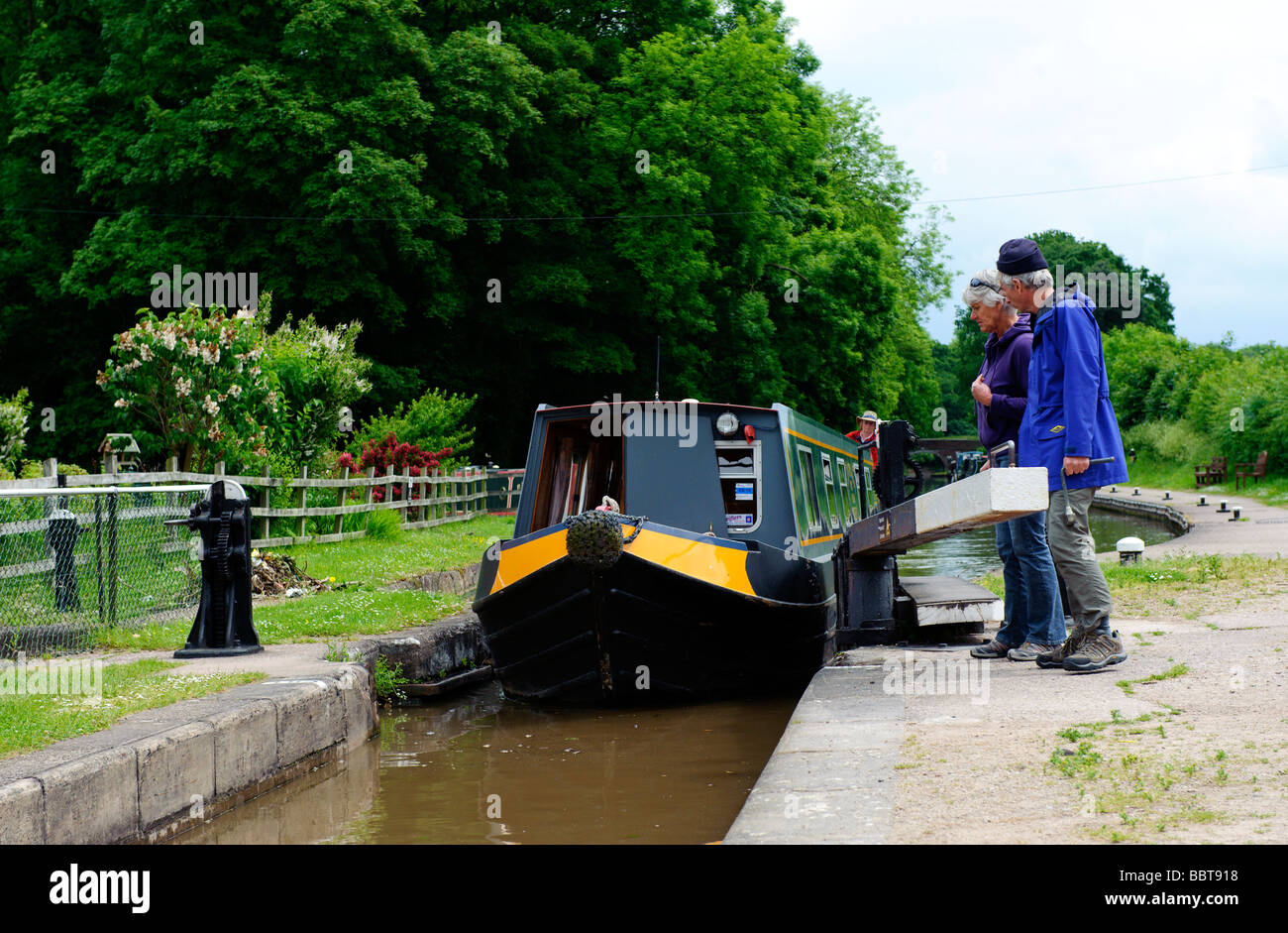 The crew of a barge negotiate their way through the gates at Tyrley ...
