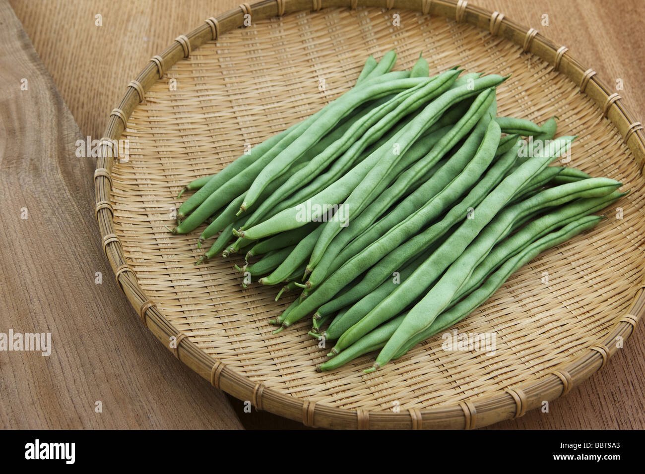 French beans in straw tray Stock Photo - Alamy