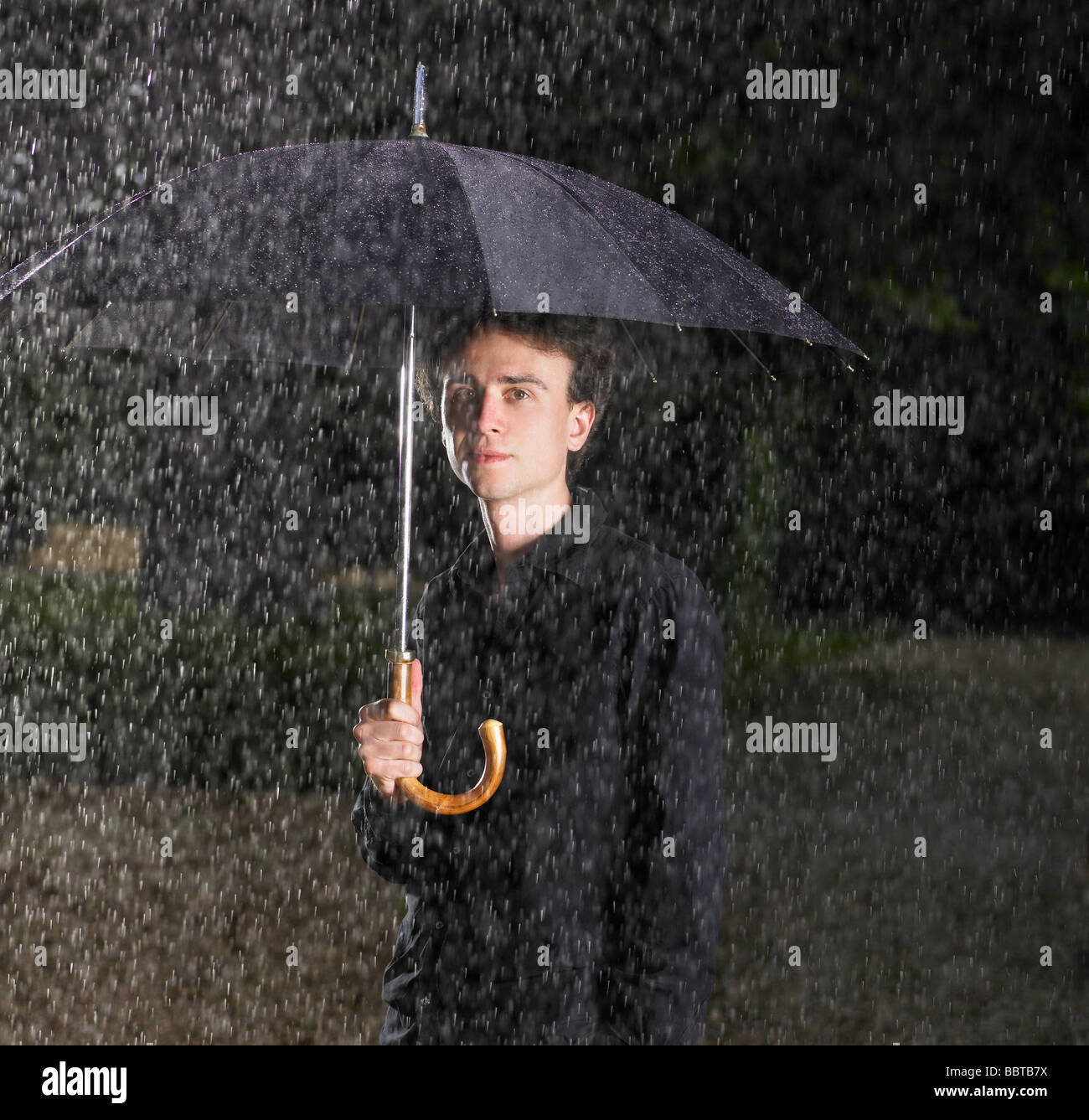 Man with an umbrella, under the rain Stock Photo - Alamy
