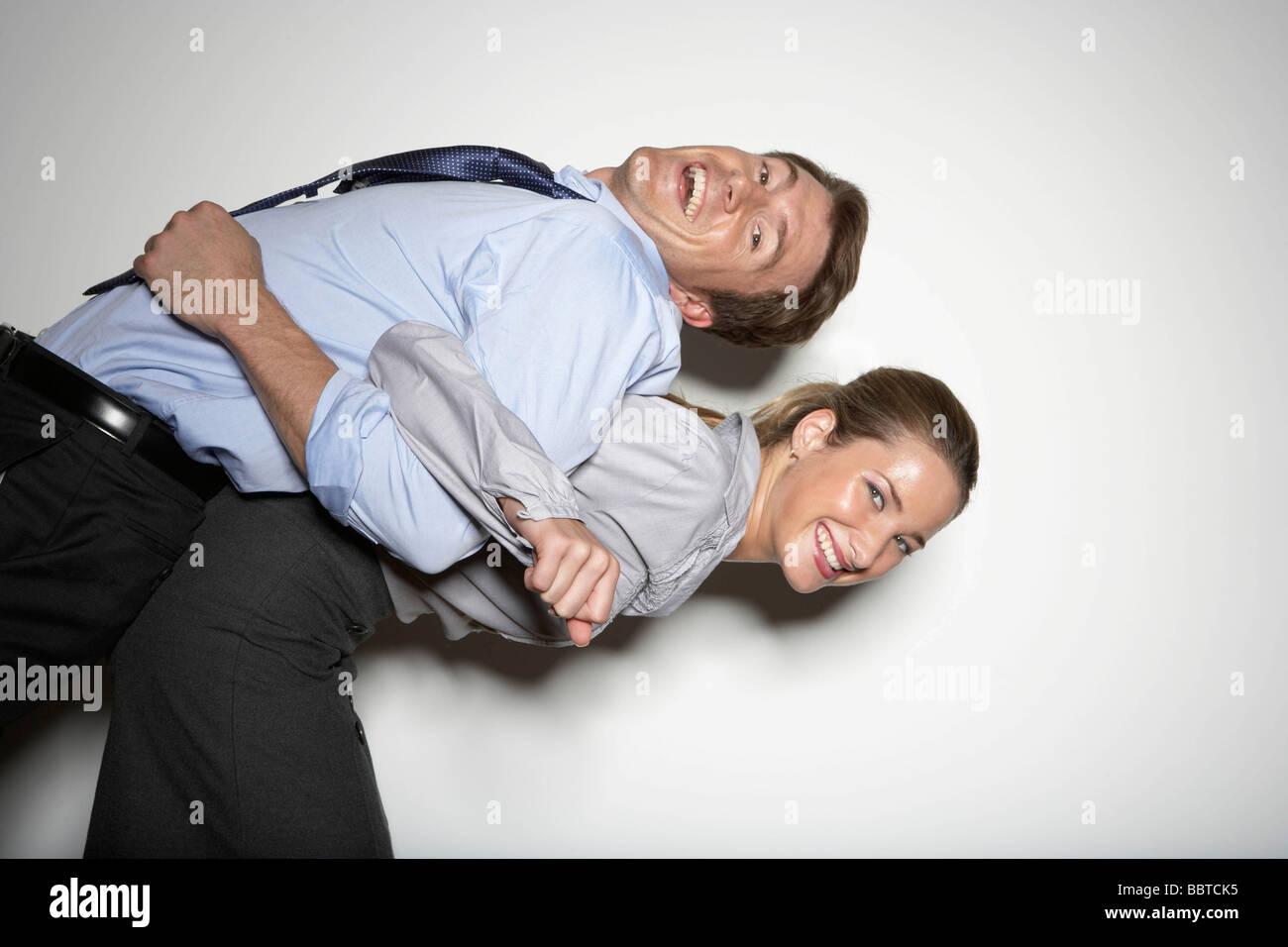 Woman lifting man on back Stock Photo - Alamy