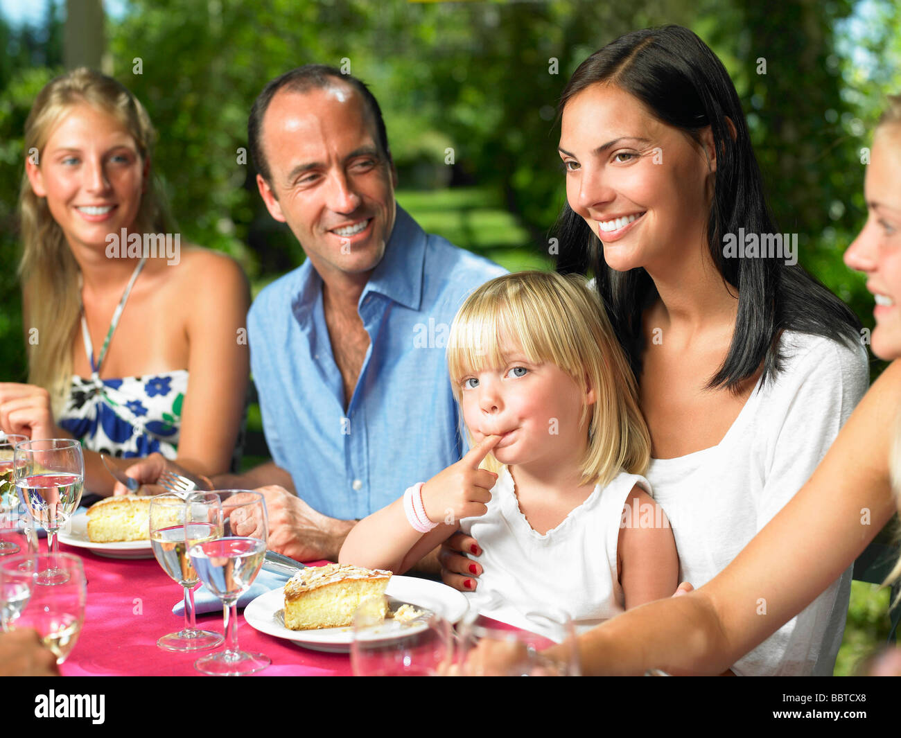Girl testing the cake with finger Stock Photo - Alamy