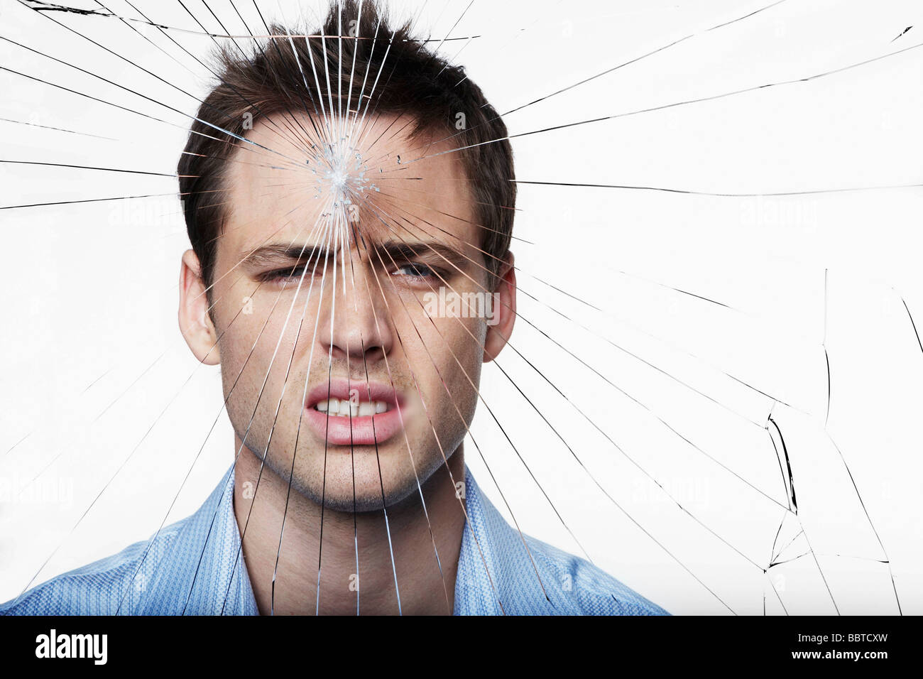 Young man behind cracked glass Stock Photo - Alamy