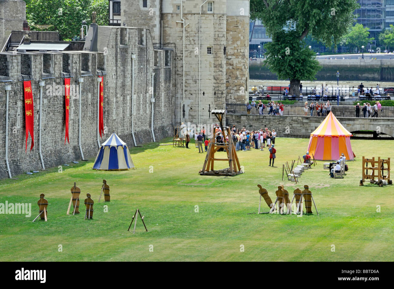 Tower of London summertime tourist activities below the walls River ...