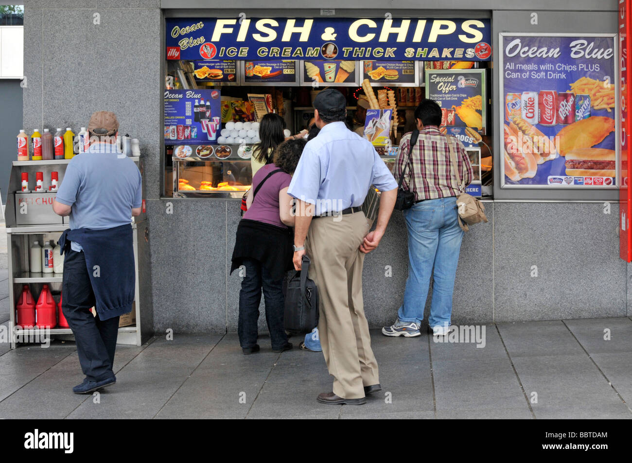 Fish and Chips shop counter back view tourist group customers shopping ...