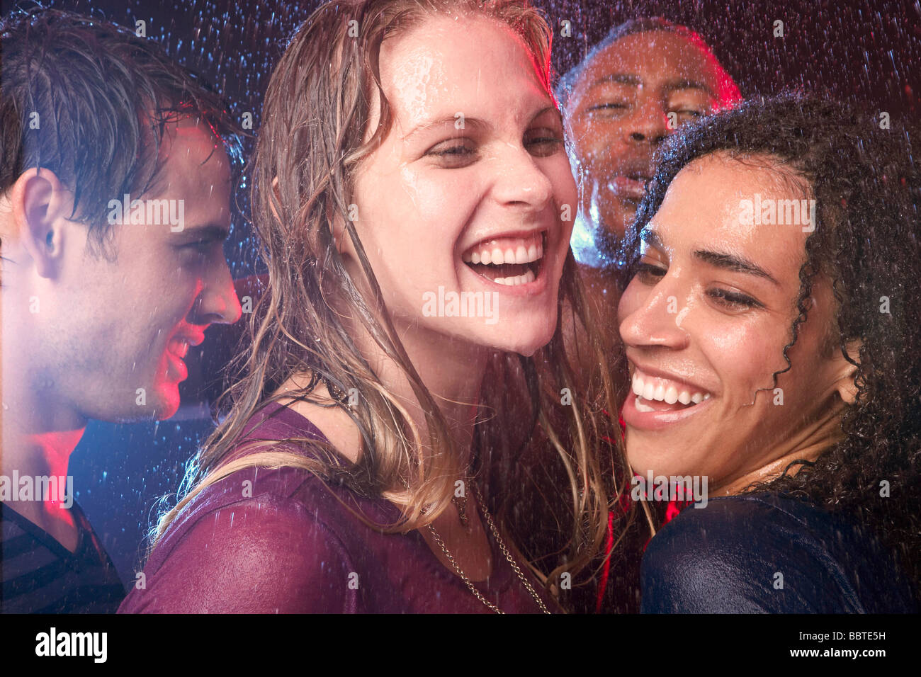 A crowd of friends dancing in rain Stock Photo - Alamy