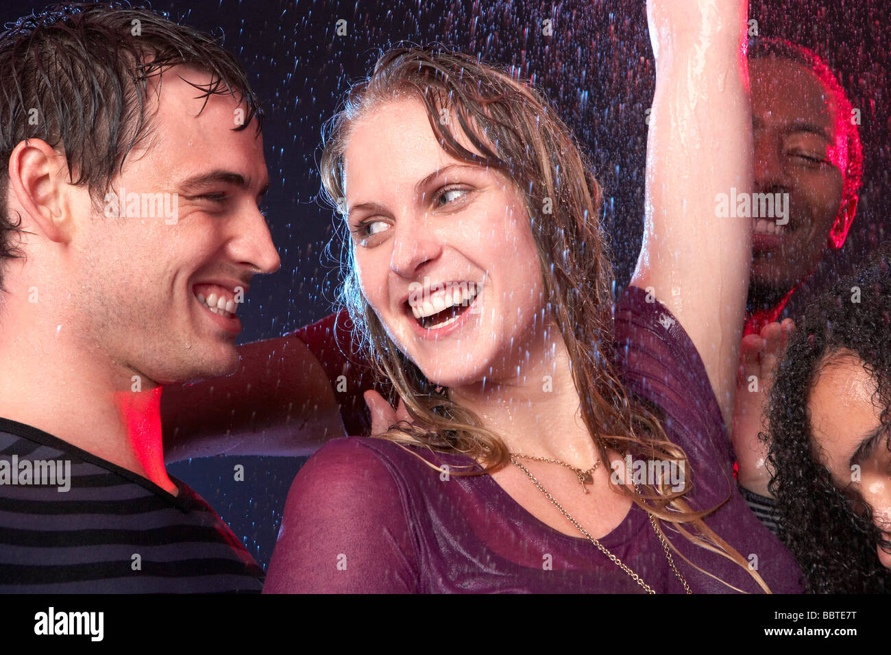 A crowd of friends dancing in rain Stock Photo - Alamy