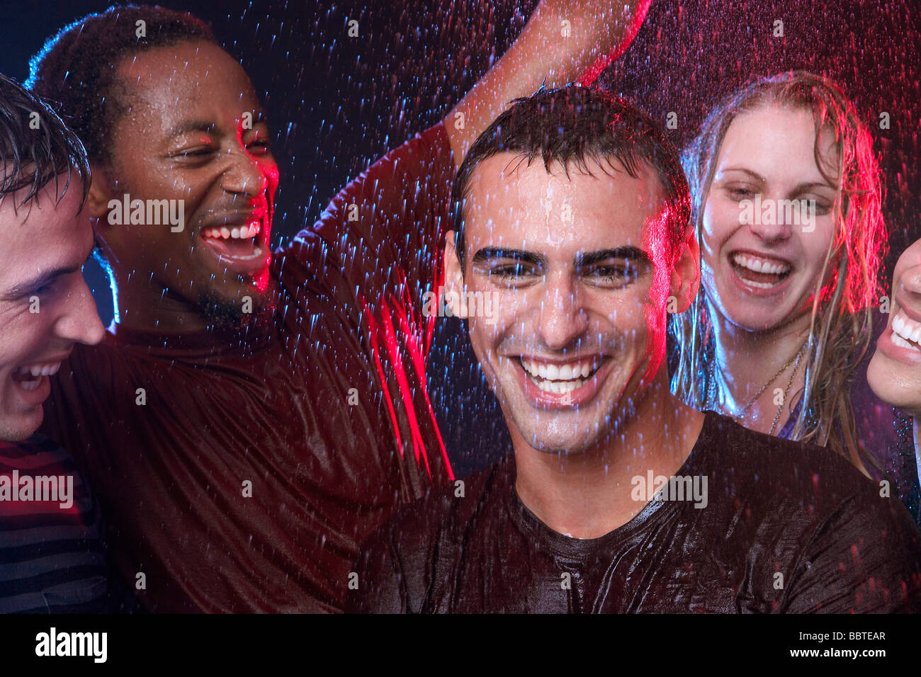 Group of friends dancing in the rain Stock Photo - Alamy