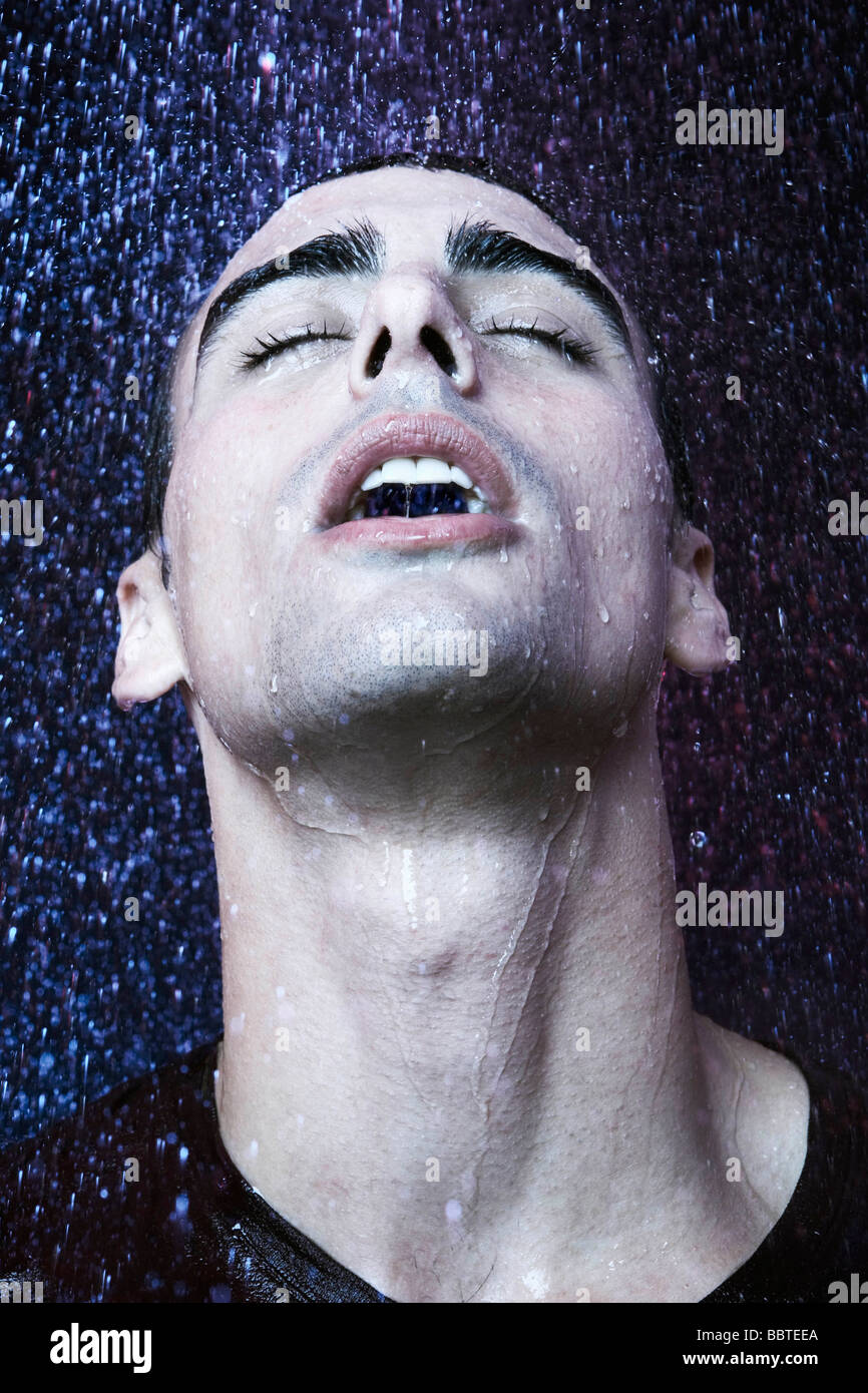 Young man in the rain Stock Photo - Alamy