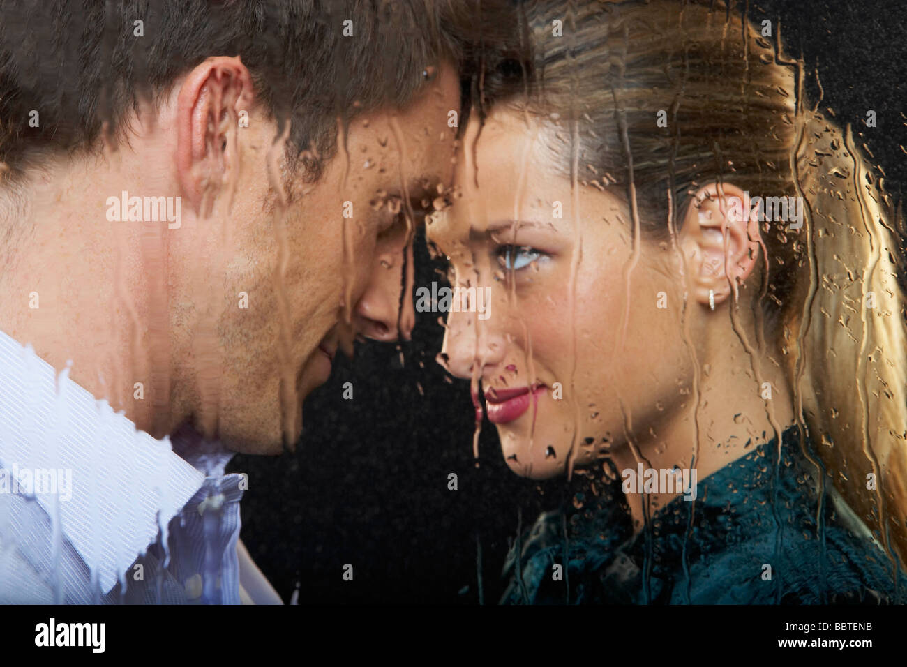 Couple behind rain covered window Stock Photo - Alamy