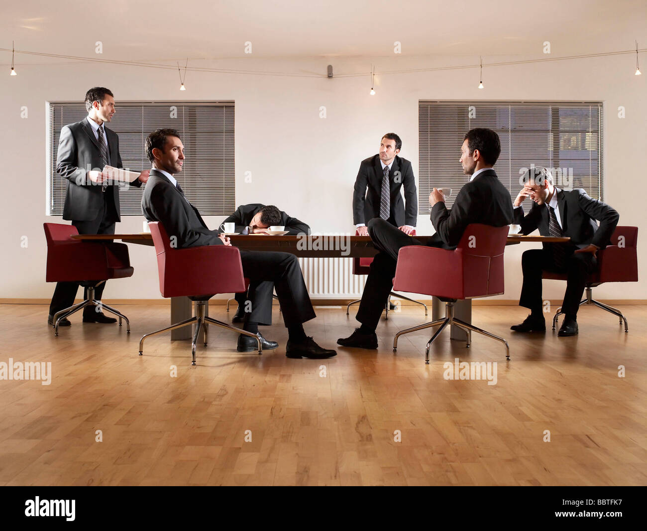 Businessmen at boardroom table Stock Photo - Alamy