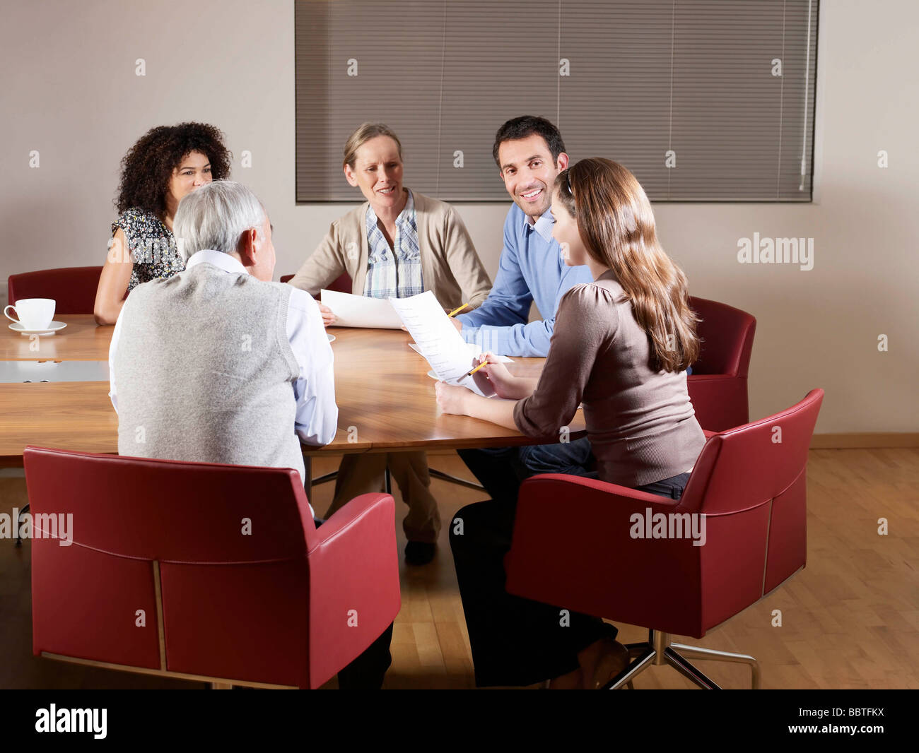 group of people at boardroom table Stock Photo - Alamy
