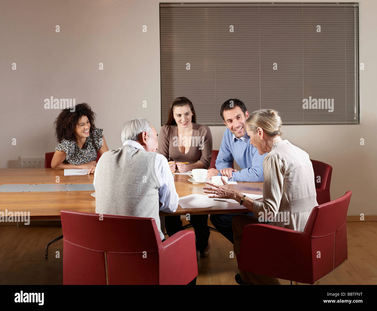 group of people at boardroom table Stock Photo - Alamy