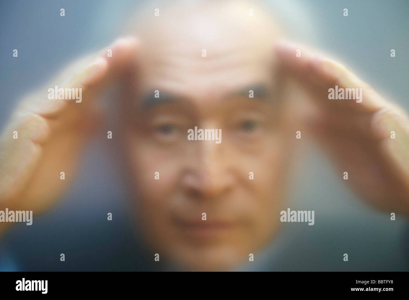 Senior man peering through screen Stock Photo - Alamy