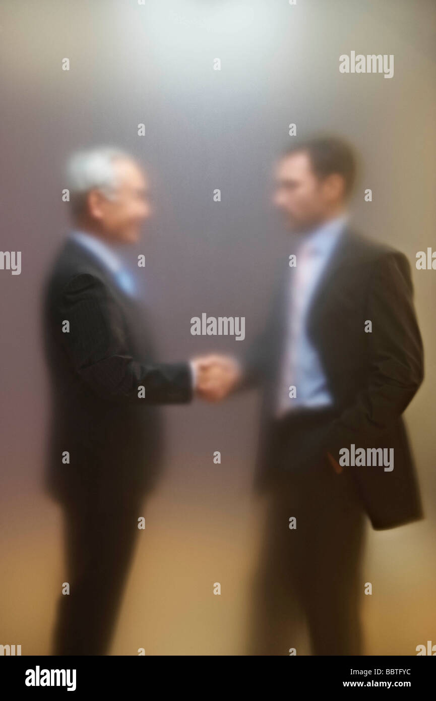 Men shaking hands behind frosted screen Stock Photo - Alamy