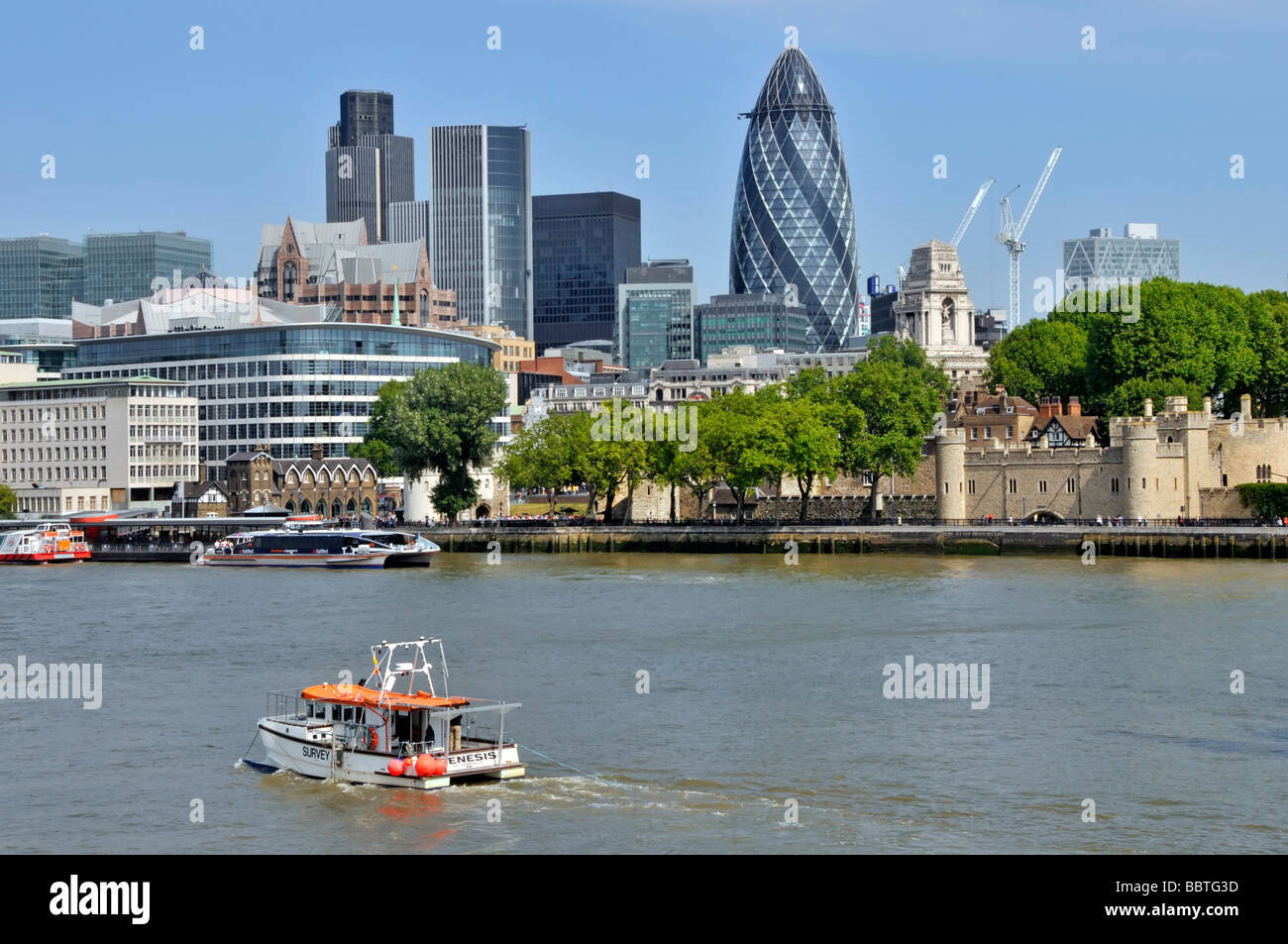 Survey boat working in the Pool of London with Tower of London & City ...
