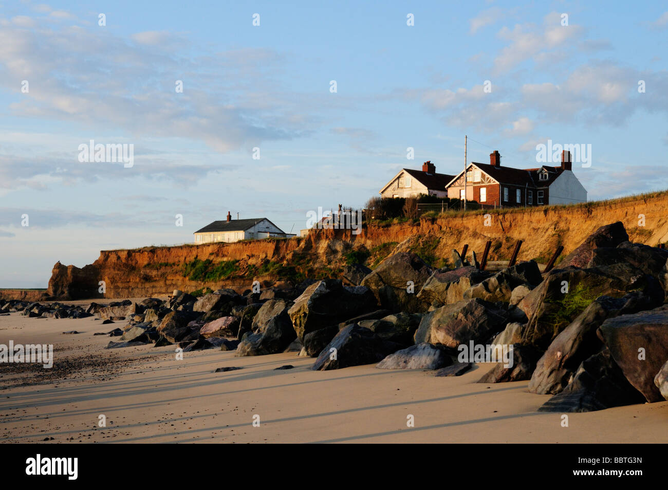 Buildings on the edge of the cliff at Happisburgh Norfolk England UK ...