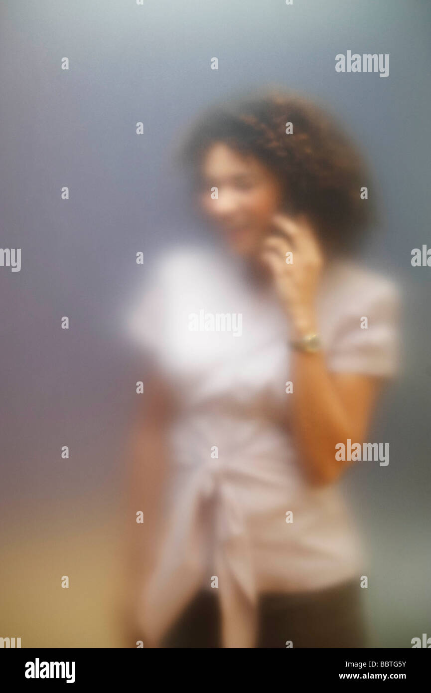 Woman on phone behind screen Stock Photo - Alamy