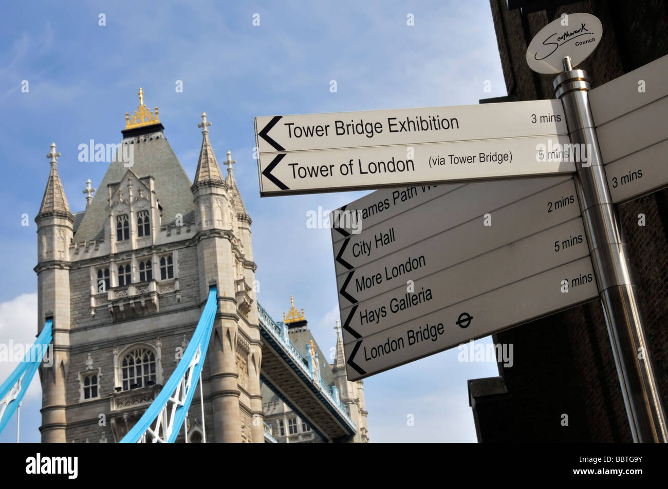 Sign posts for pedestrians beside Tower Bridge London Stock Photo - Alamy