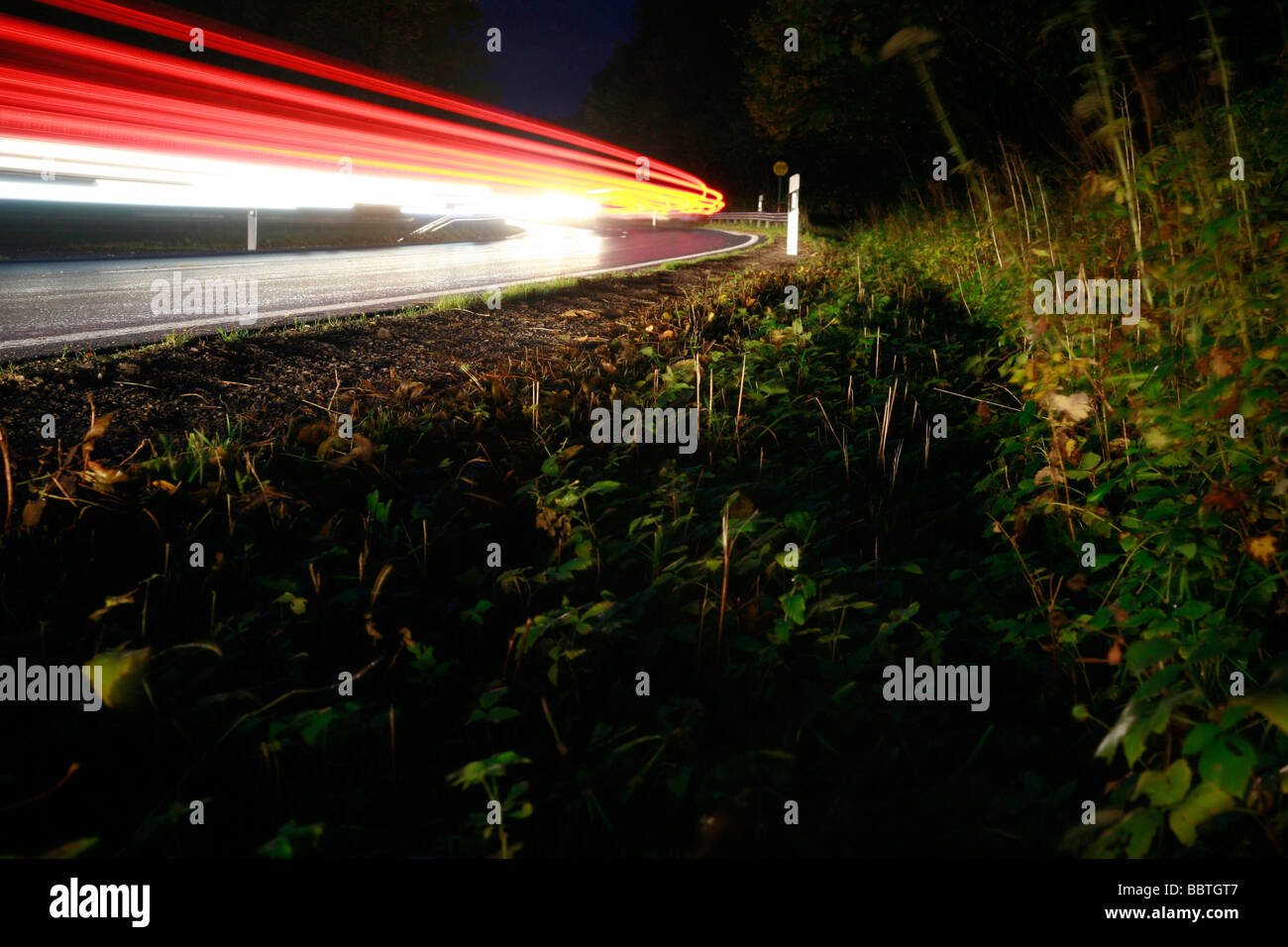 Roadside with light streaks from cars Stock Photo - Alamy