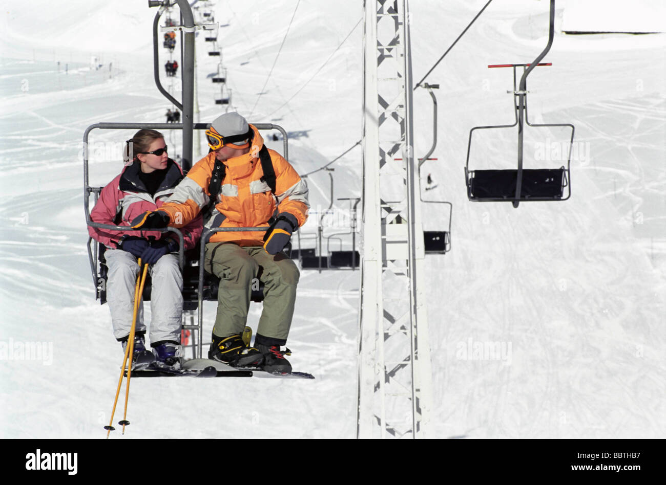 Couple sitting on chair lift Stock Photo - Alamy