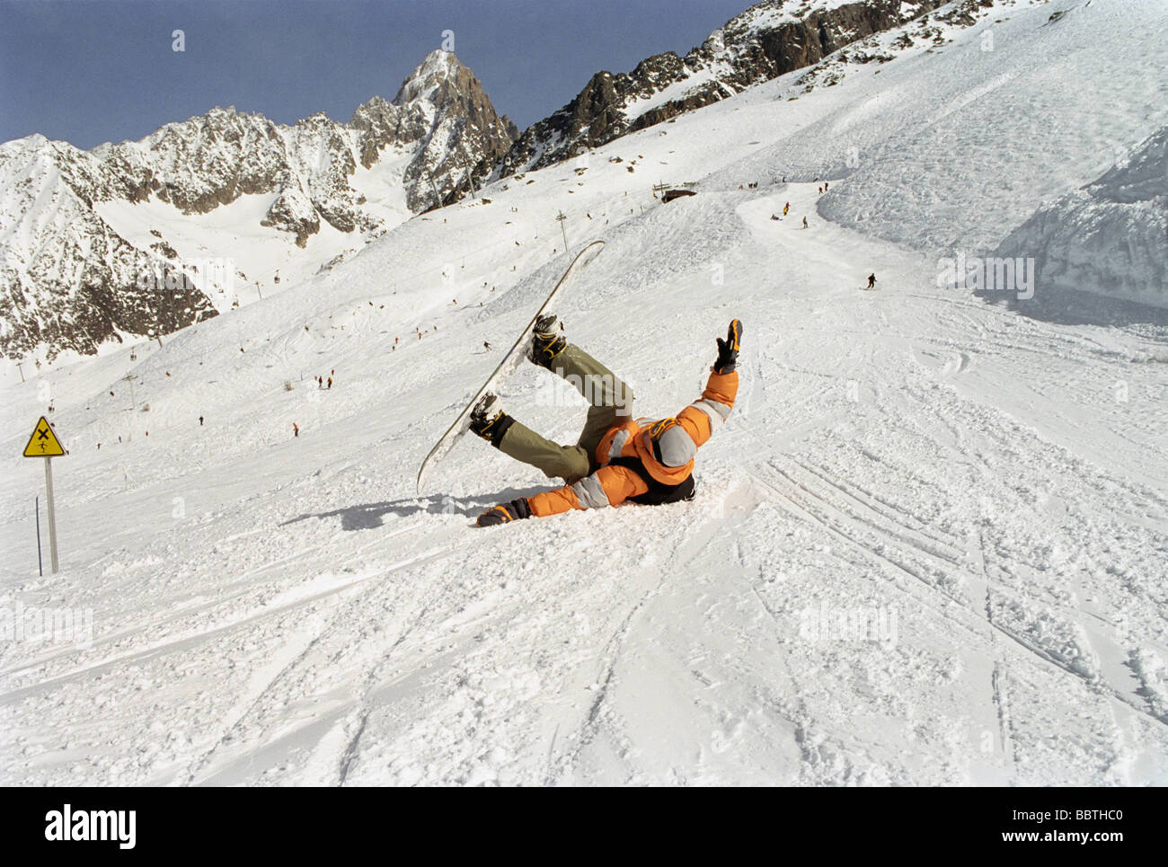 Boy rolling in snow with a snowboard Stock Photo - Alamy