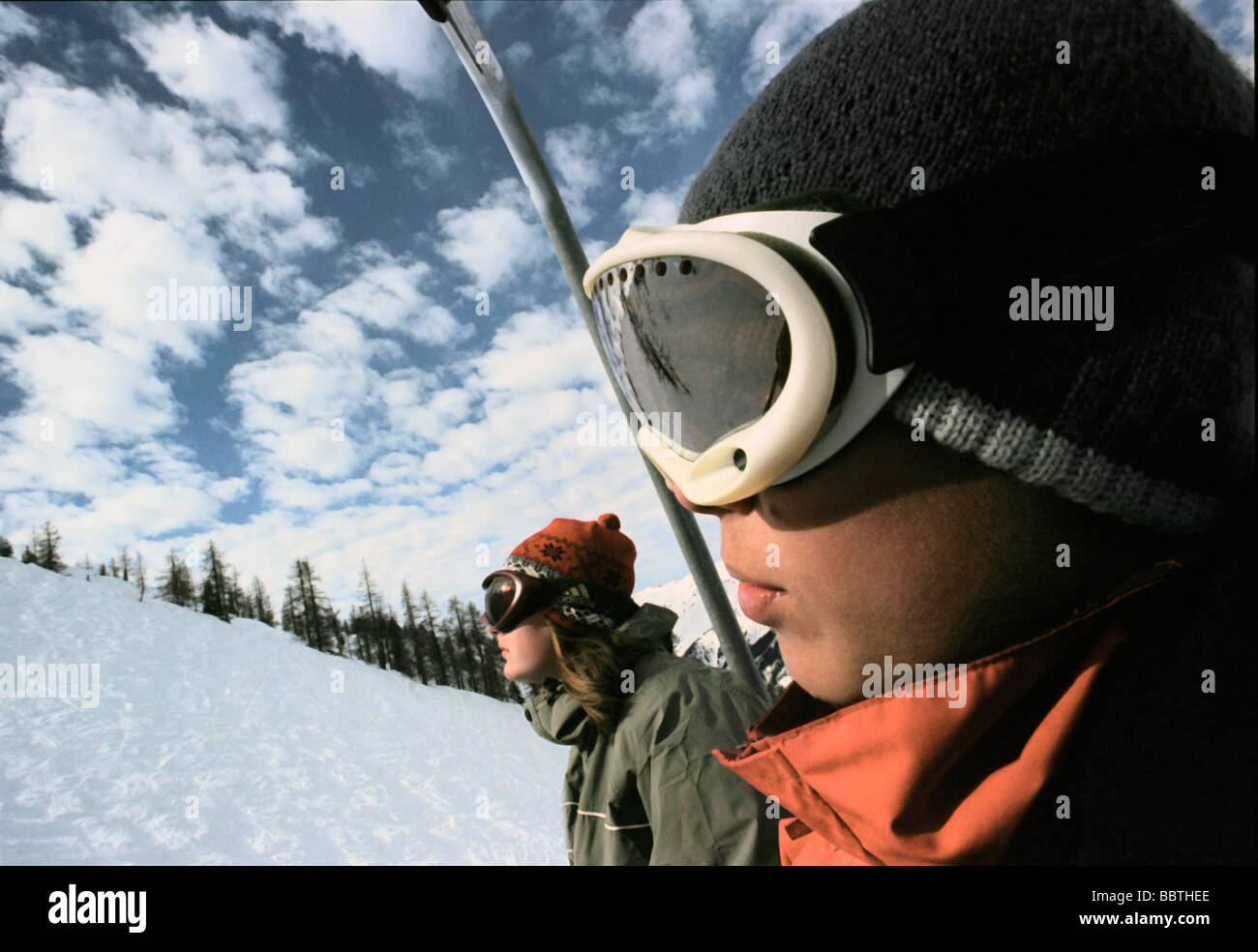 Couple riding on chair lift Stock Photo - Alamy