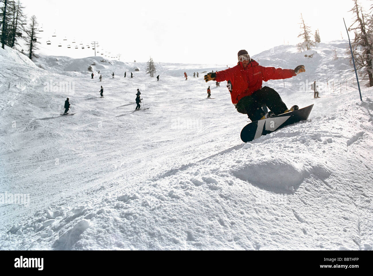 Male in action on a snowboard Stock Photo - Alamy