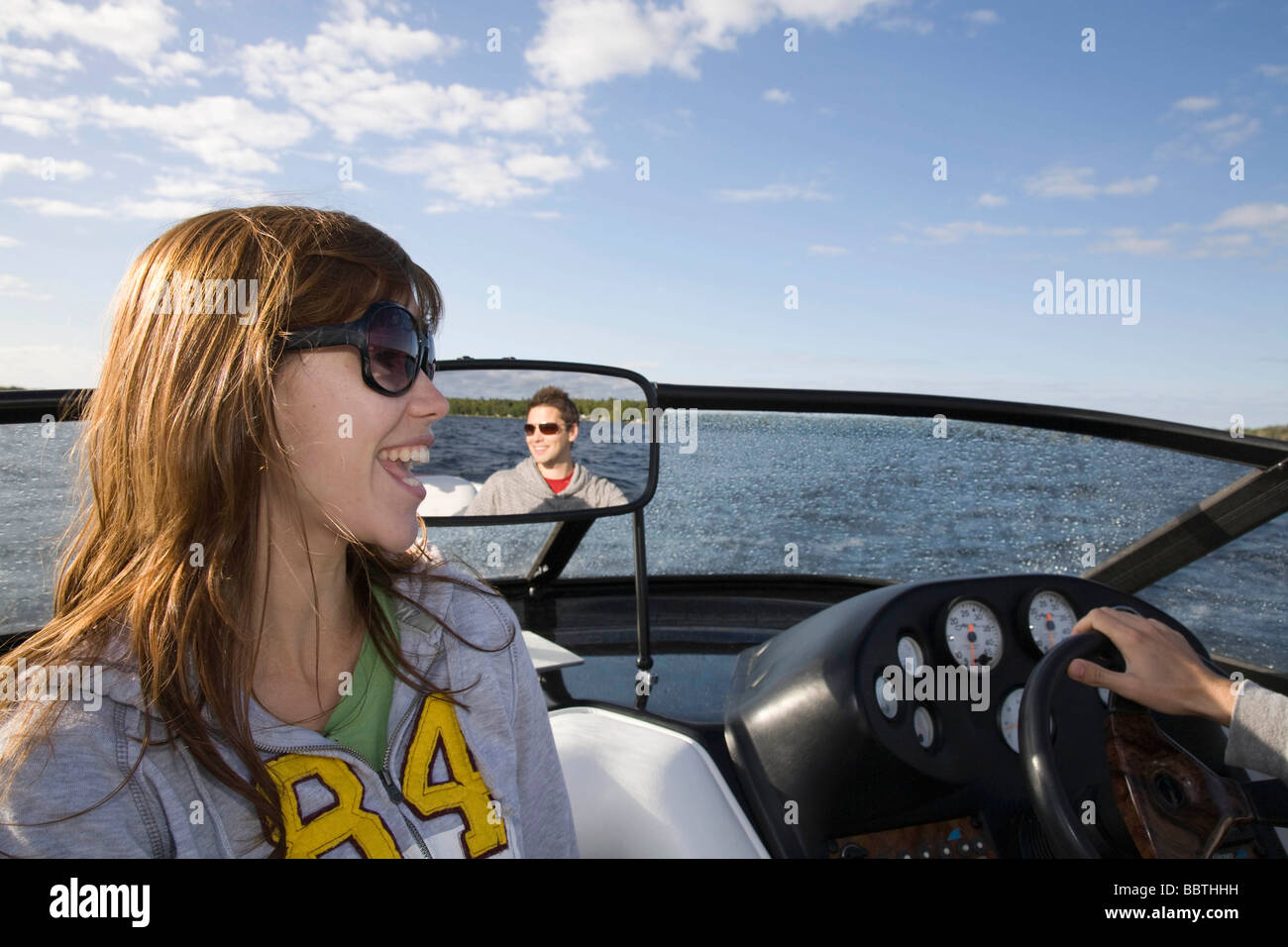 Couple laughing in speedboat Stock Photo - Alamy