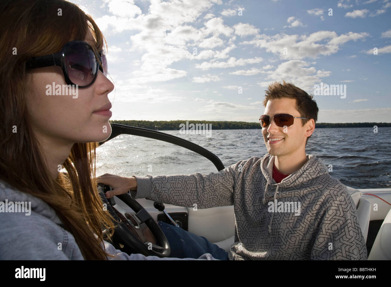 Couple in speedboat on lake Stock Photo - Alamy