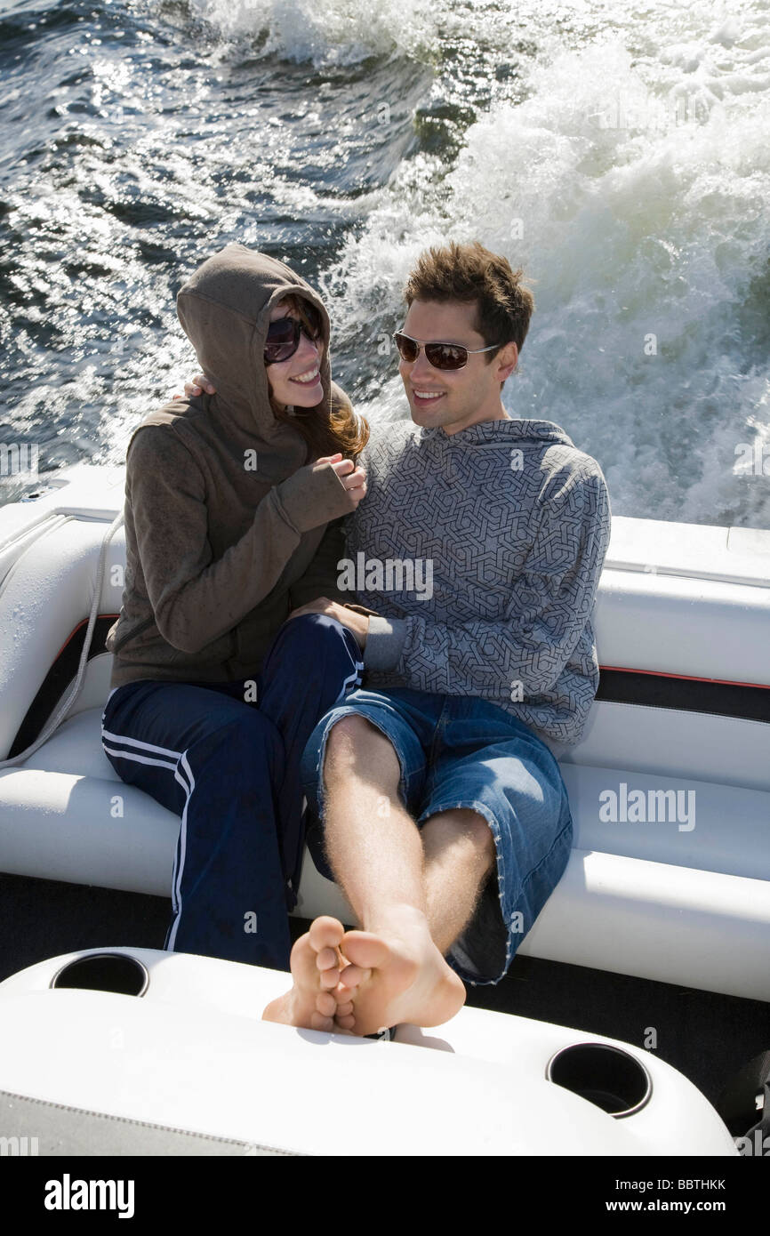 Couple riding in speedboat on lake Stock Photo - Alamy
