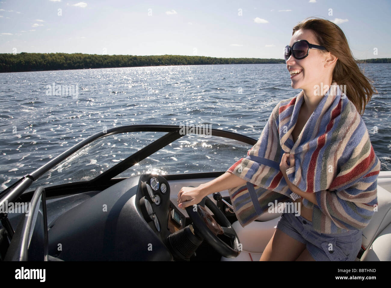 Woman driving speedboat on lake Stock Photo - Alamy