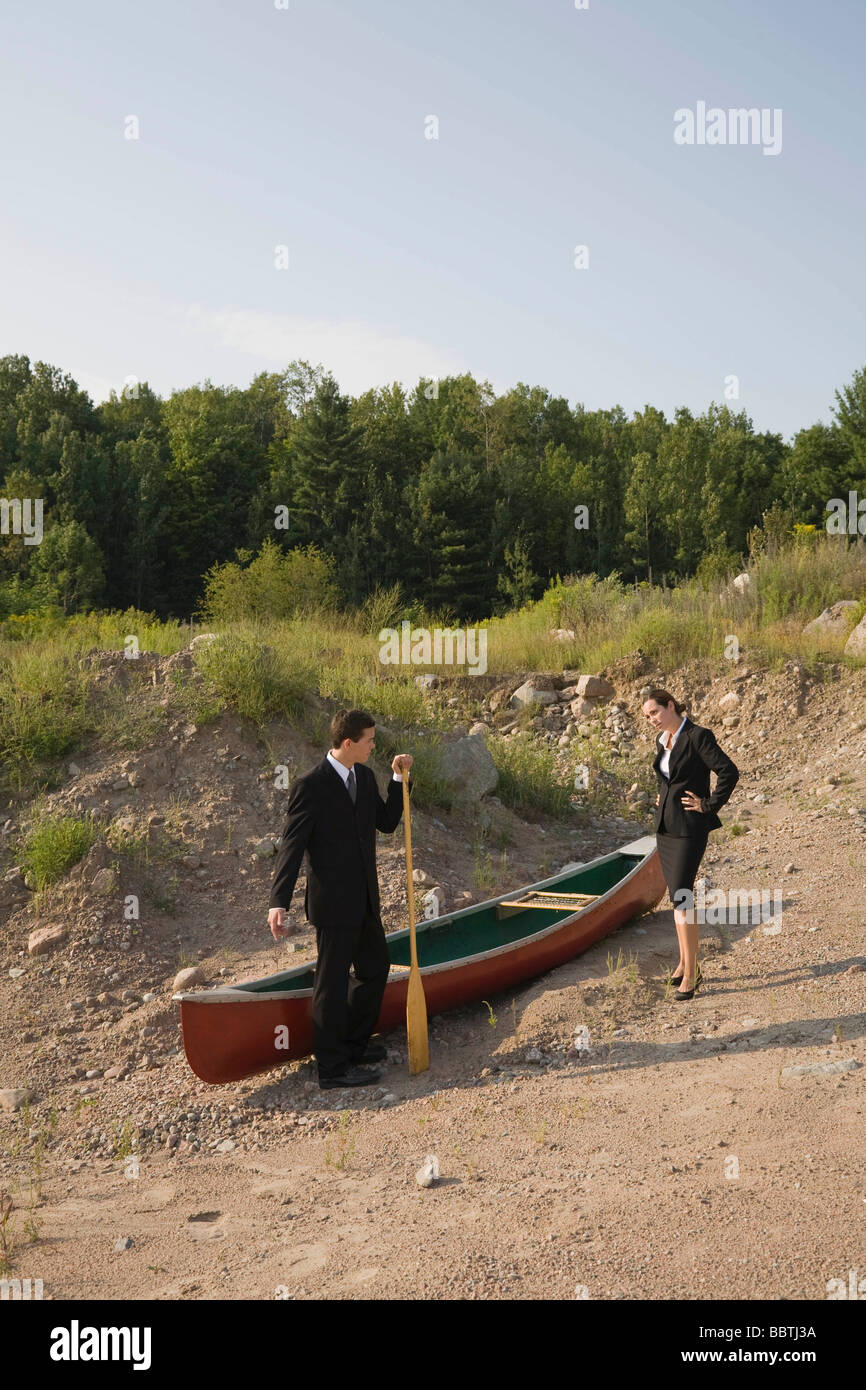 Business people in stranded canoe Stock Photo - Alamy
