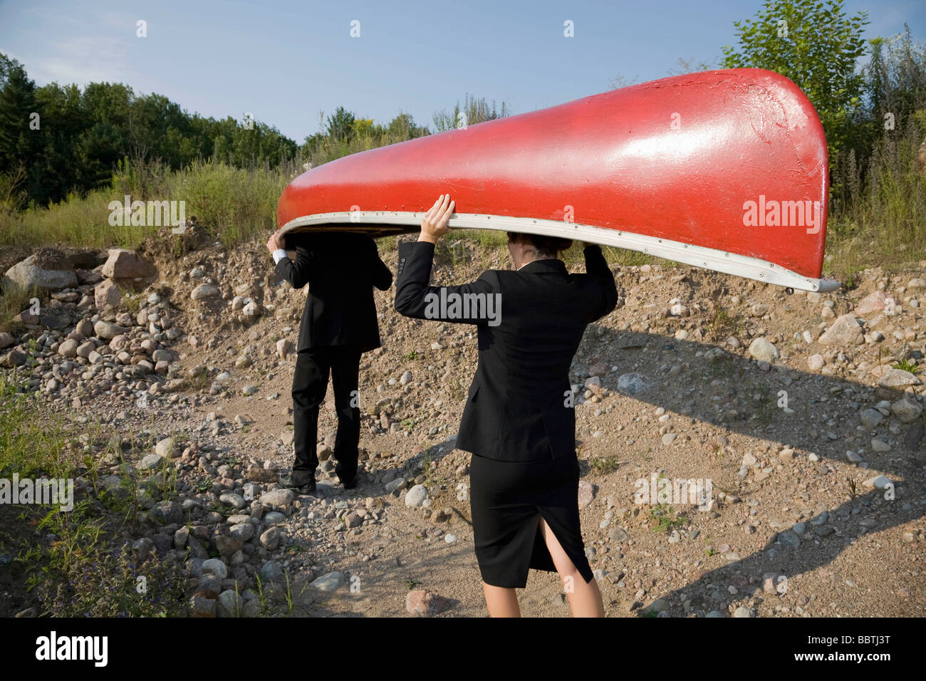 Business people carrying canoe Stock Photo - Alamy