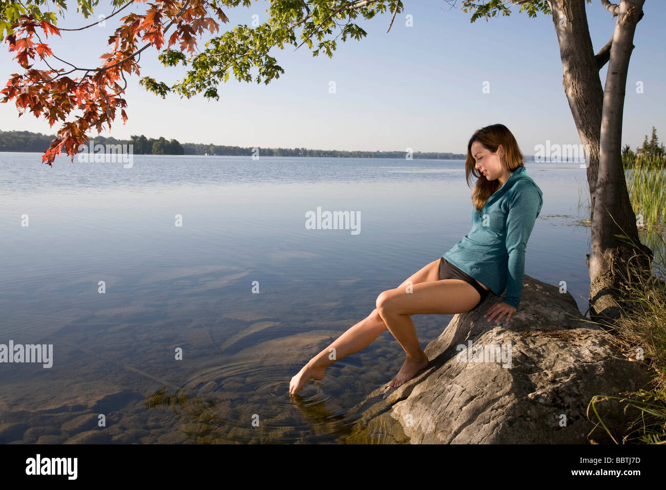 Woman testing water with toe Stock Photo - Alamy
