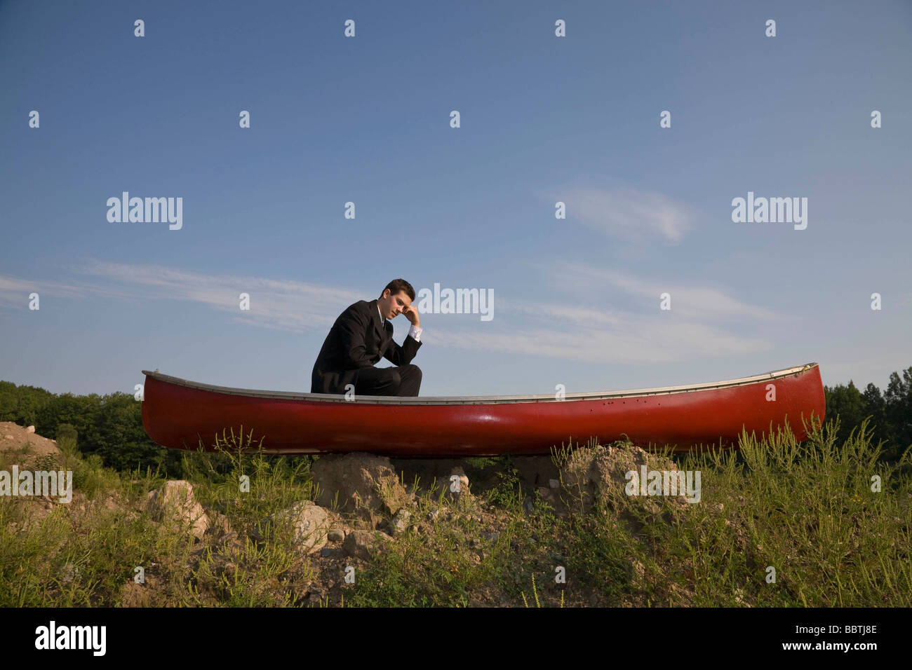 Business man stranded in canoe Stock Photo - Alamy