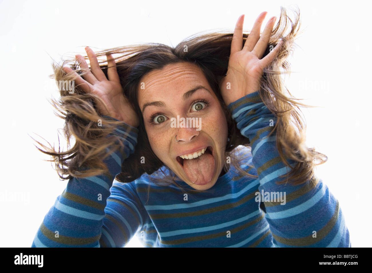 Woman making funny face at camera Stock Photo - Alamy