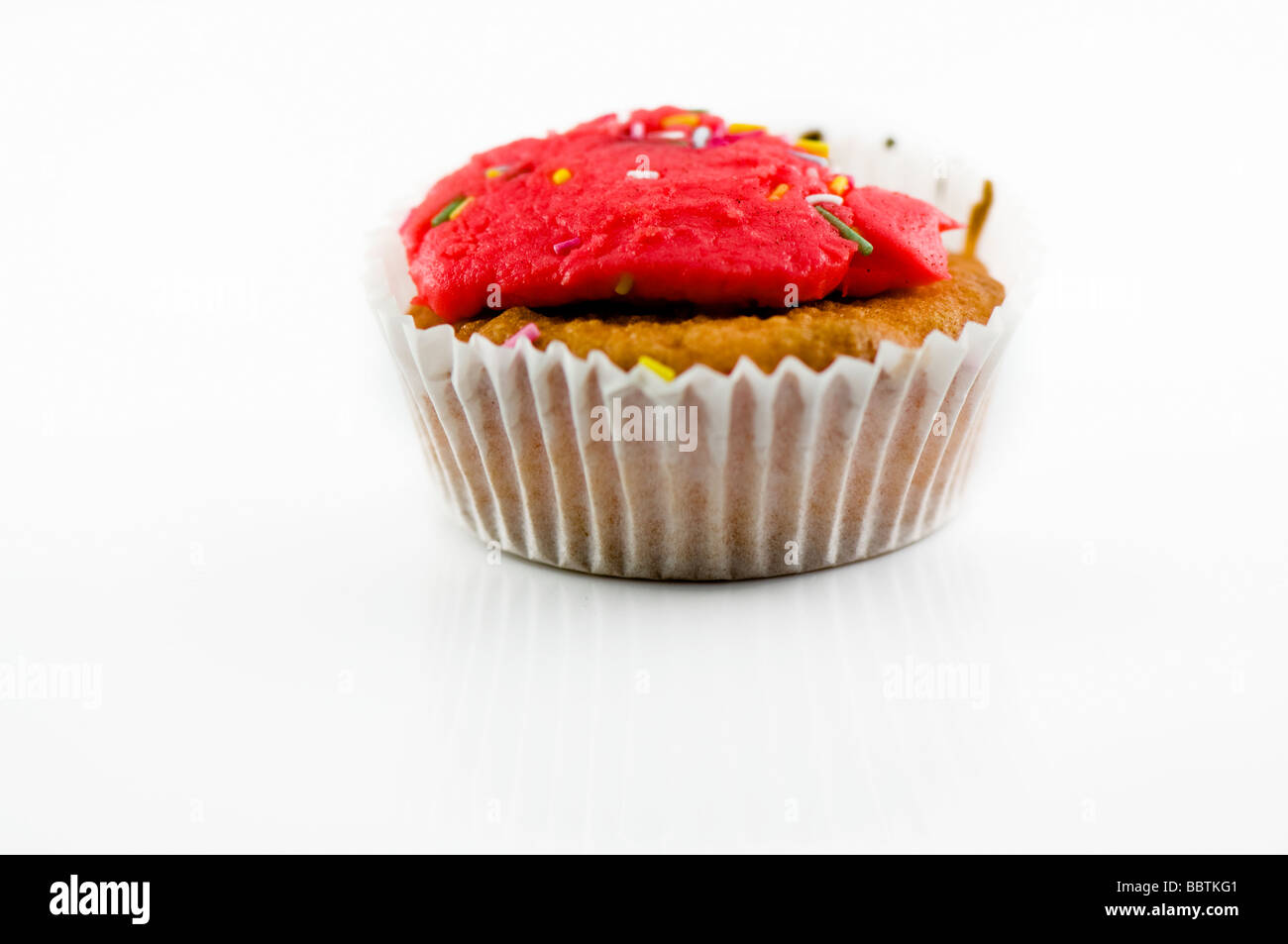 A tasty muffin with red cream isolated on white background Stock Photo ...
