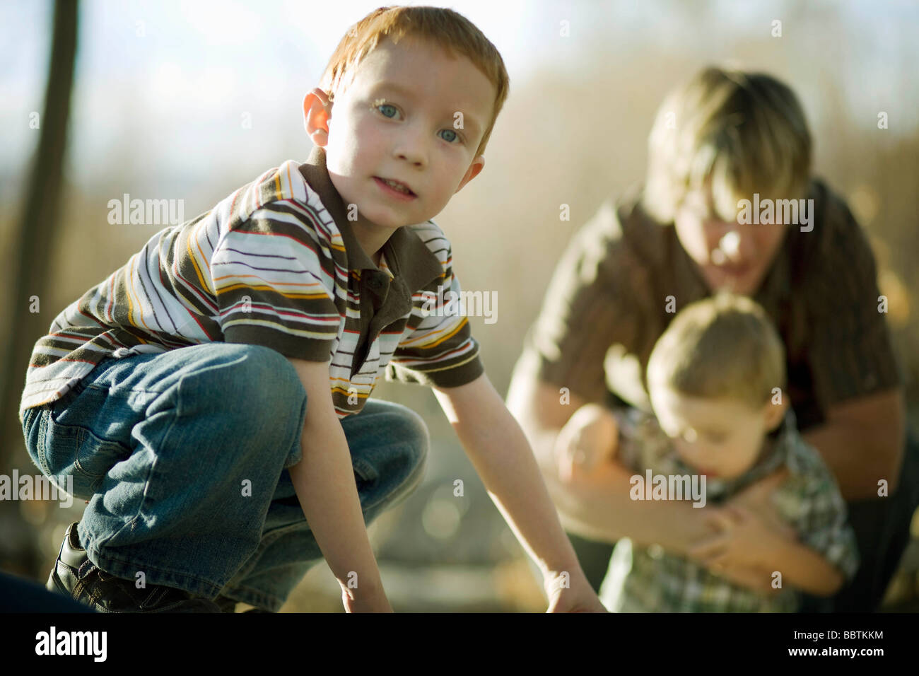 Father playing with two young sons Stock Photo - Alamy