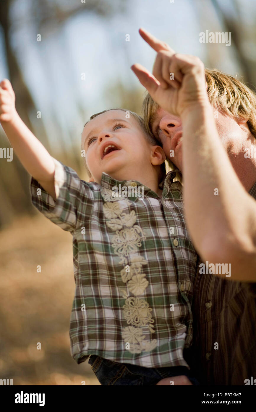 Father pointing in air with young son Stock Photo - Alamy