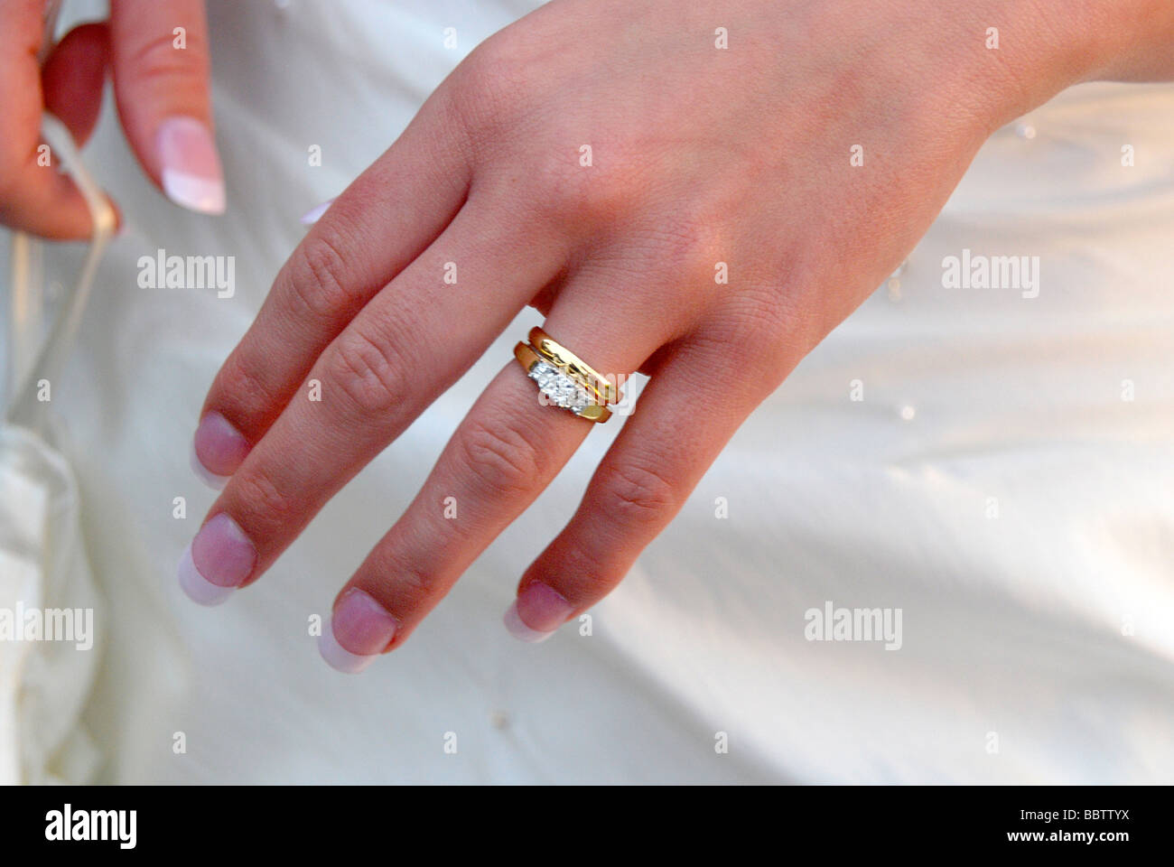 A bride shows off her golden wedding ring on her wedding day Stock ...