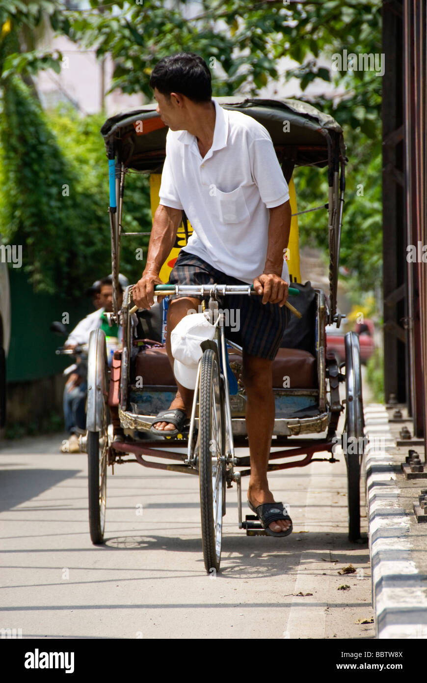 Tricycle taxi rider in Chiang Mai Thailand Stock Photo - Alamy