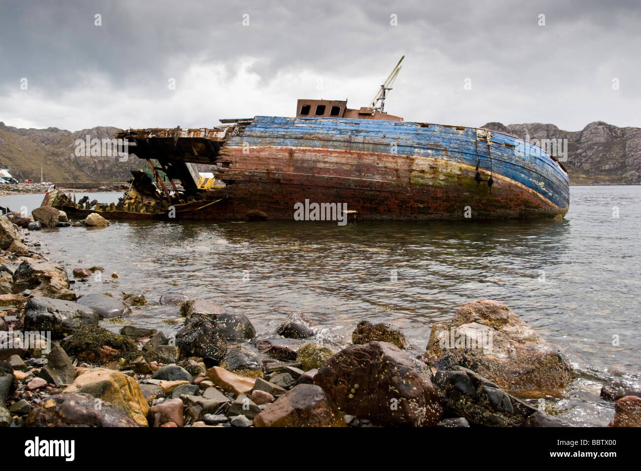 A wrecked fishing boat on the beach at the small village of Diabaig in ...