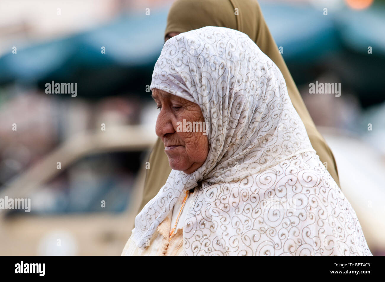Moroccan woman wearing the traditional abaya in the market in Djemma el ...