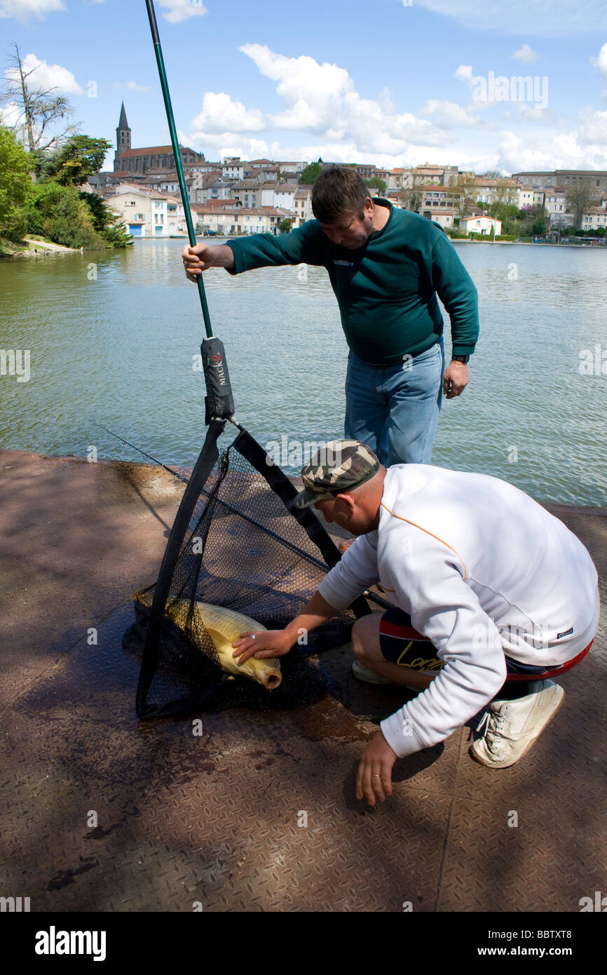 two men fishing for carp in the grande bassin on the Canal du Midi at ...