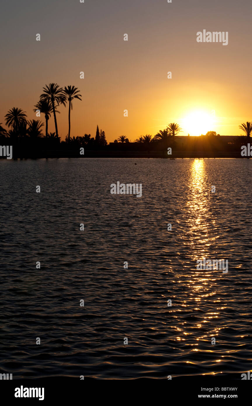 Sunset over the basin of Menara Gardens in Marrakesh Morocco Stock ...