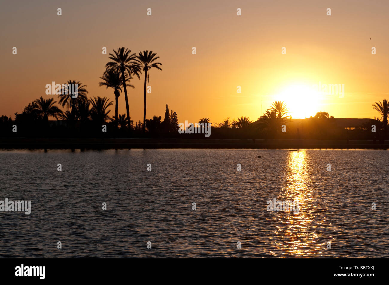 Sunset over the basin of Menara Gardens in Marrakesh Morocco Stock ...