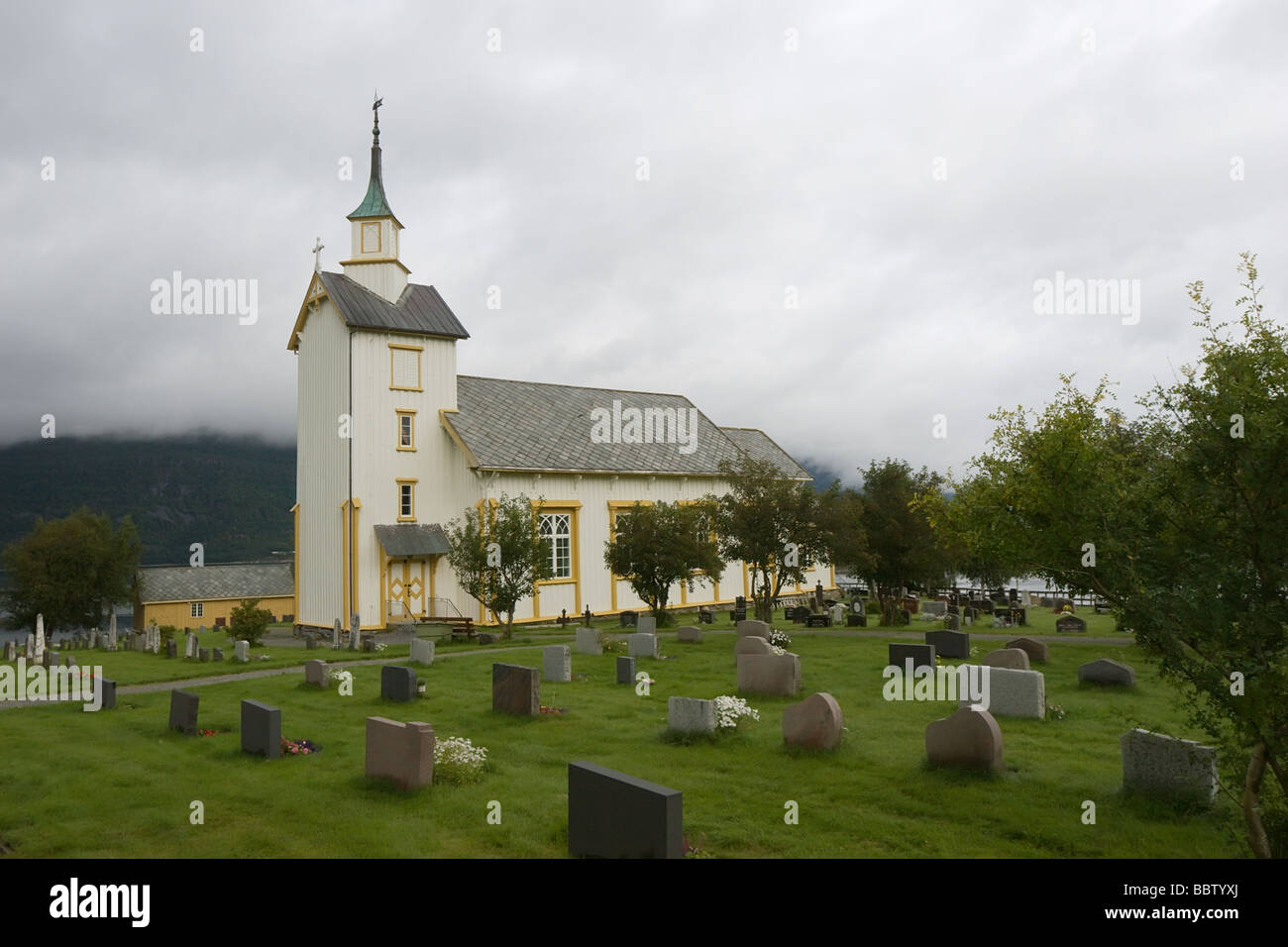 Little cemetery near white rural church Stock Photo - Alamy