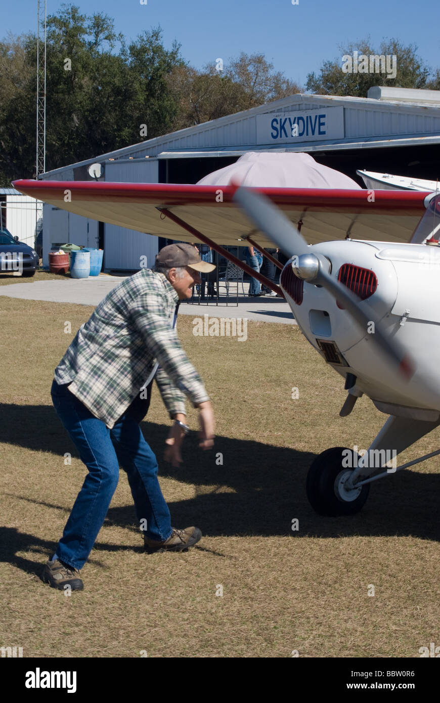 Hand starting or propping an airplane Stock Photo - Alamy