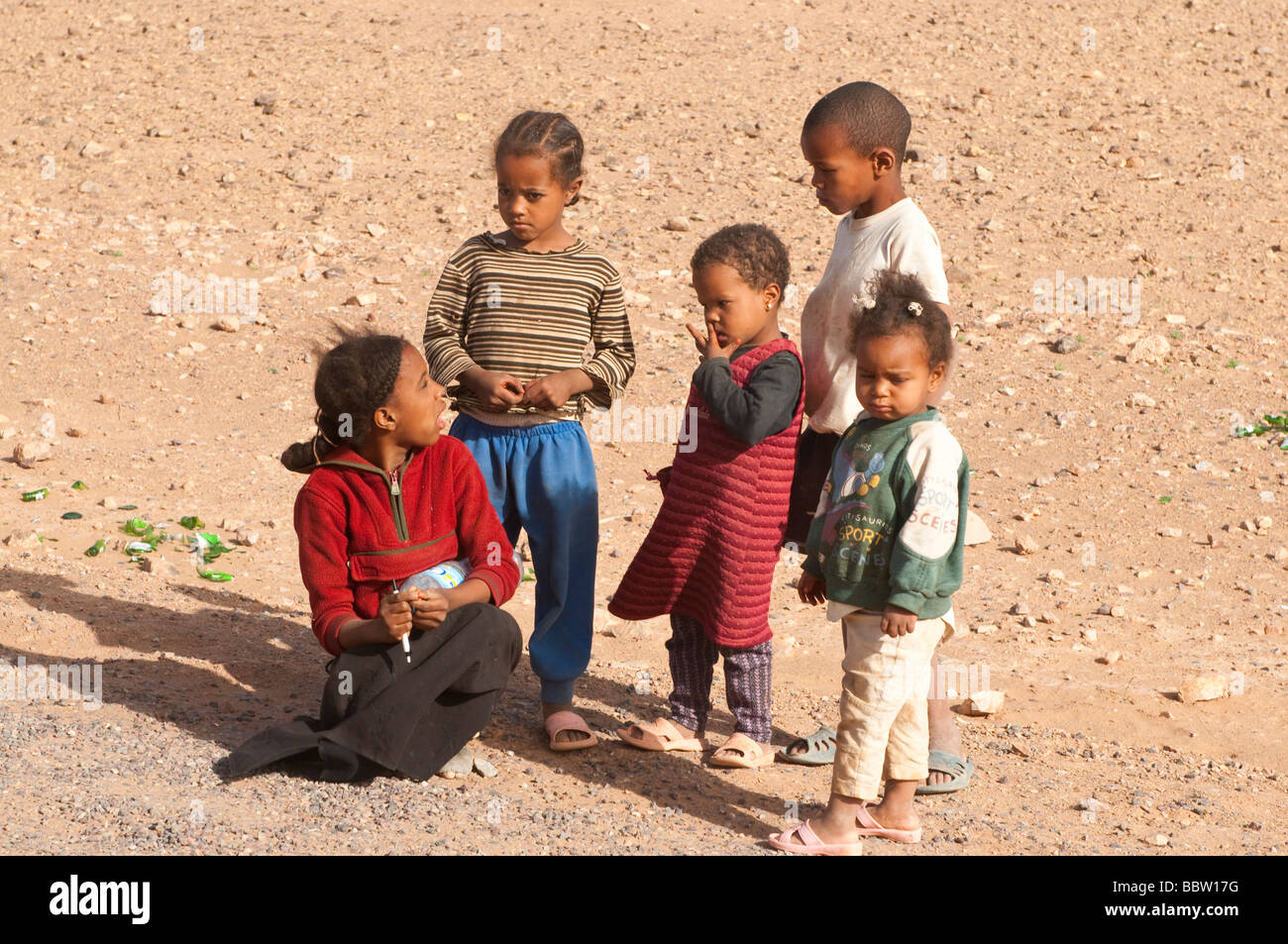 Berber children playing in the sand in the desert of Southern Morocco ...