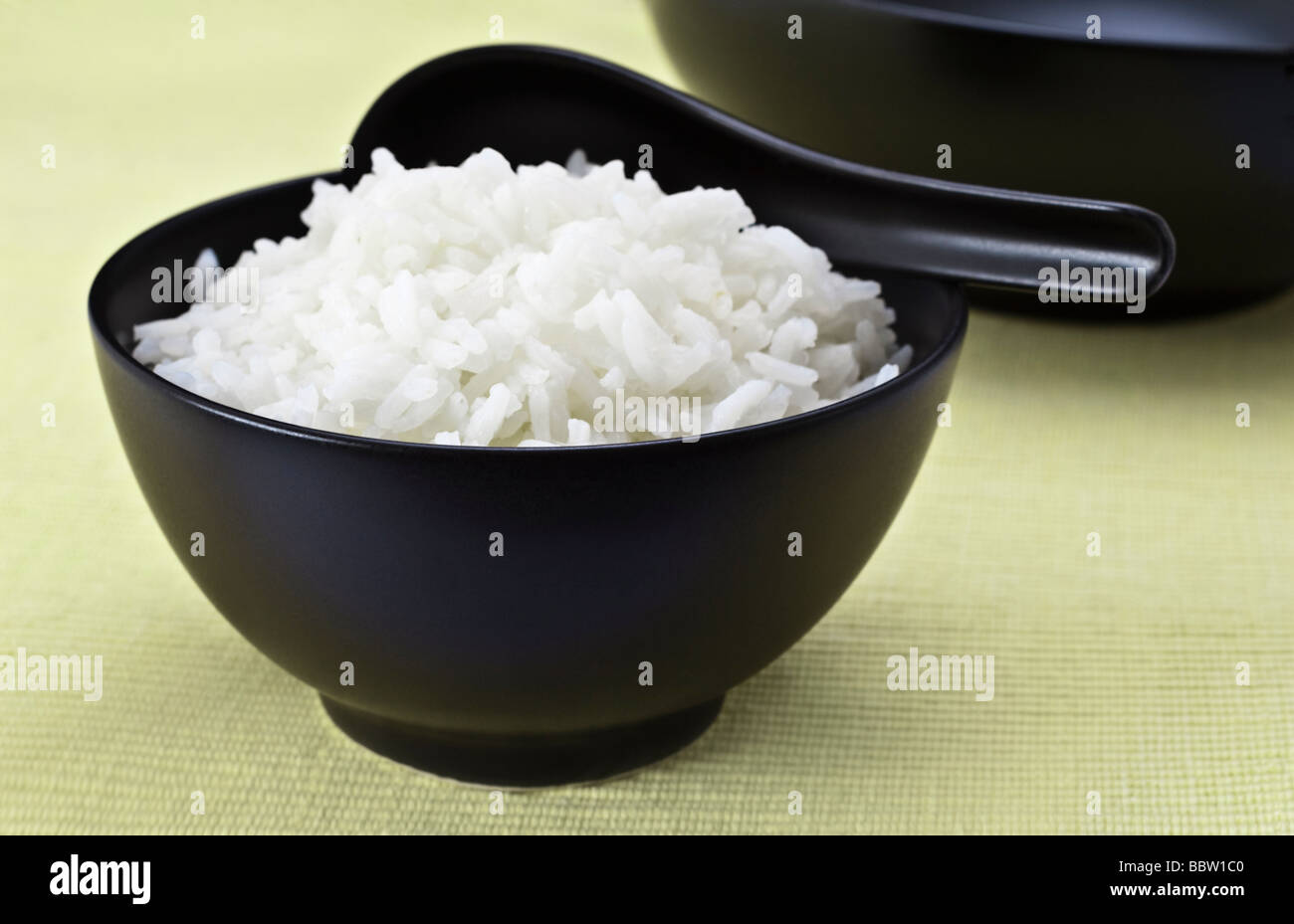 White rice in a black bowl Stock Photo - Alamy